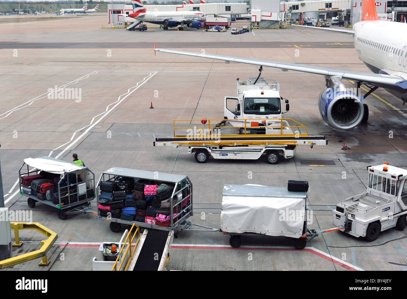 Airside baggage handling at Gatwick airport, UK Stock Photo - Alamy