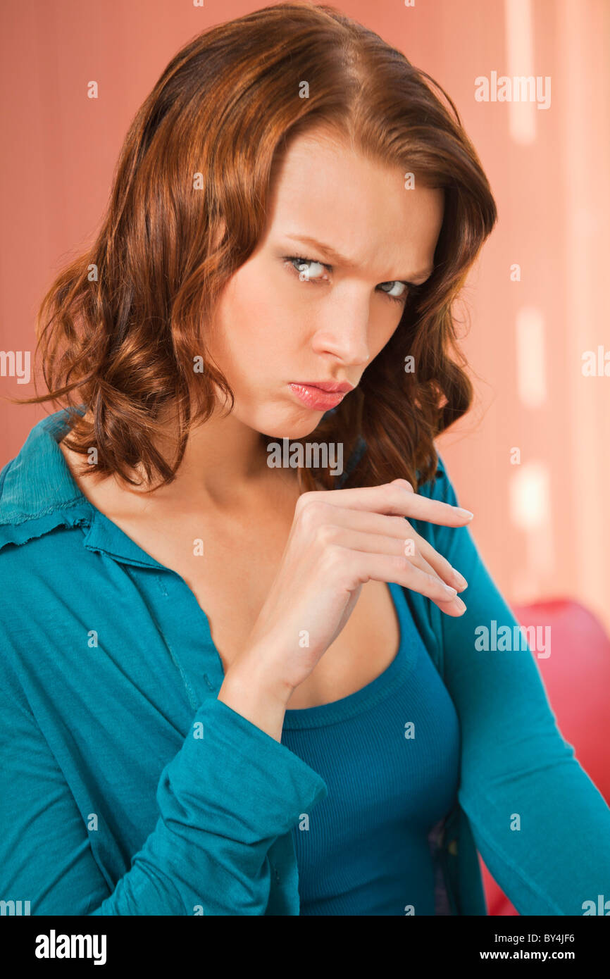Young woman pouting Stock Photo - Alamy