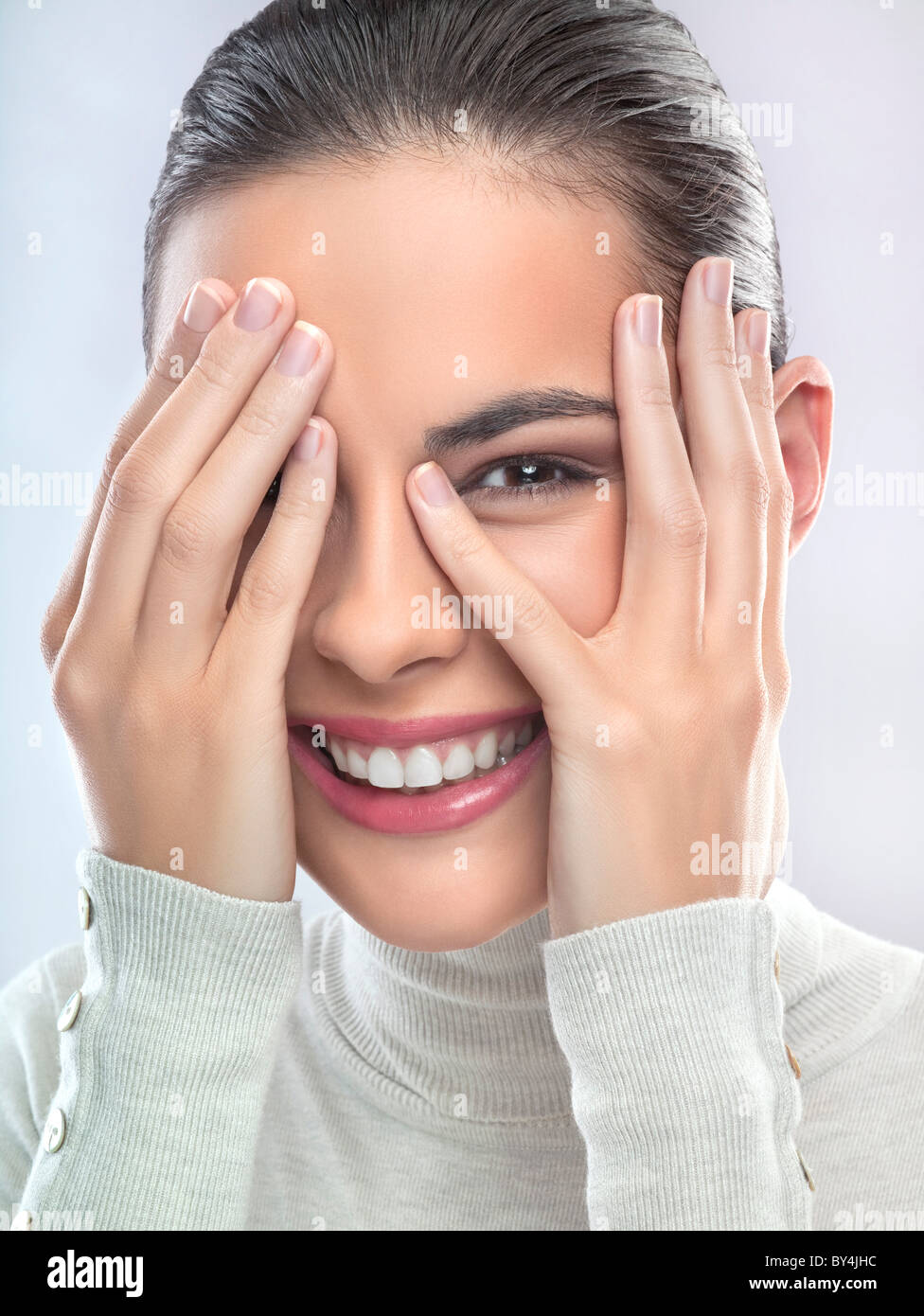 Young woman covering face with hands Stock Photo - Alamy
