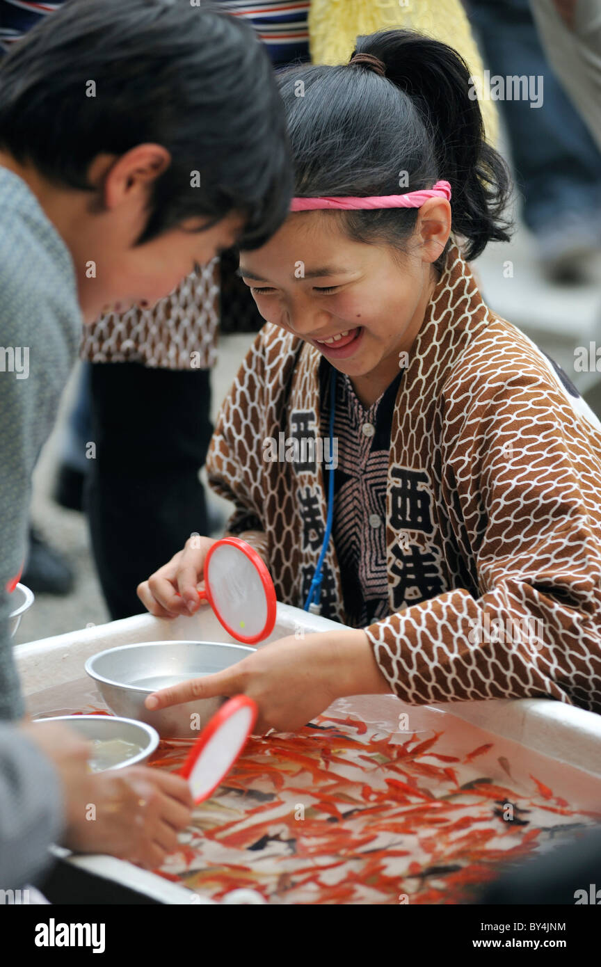 Japanese girl catching fish at Sanja Matsuri, Asakusa, Tokyo, Japan ...