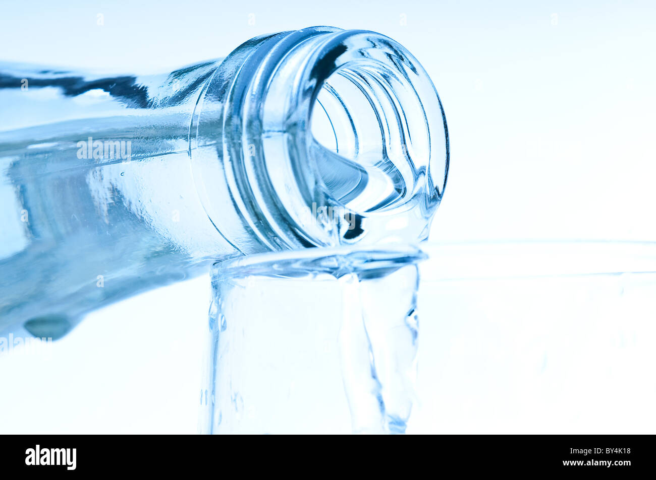 bottle pouring water into glass Stock Photo - Alamy