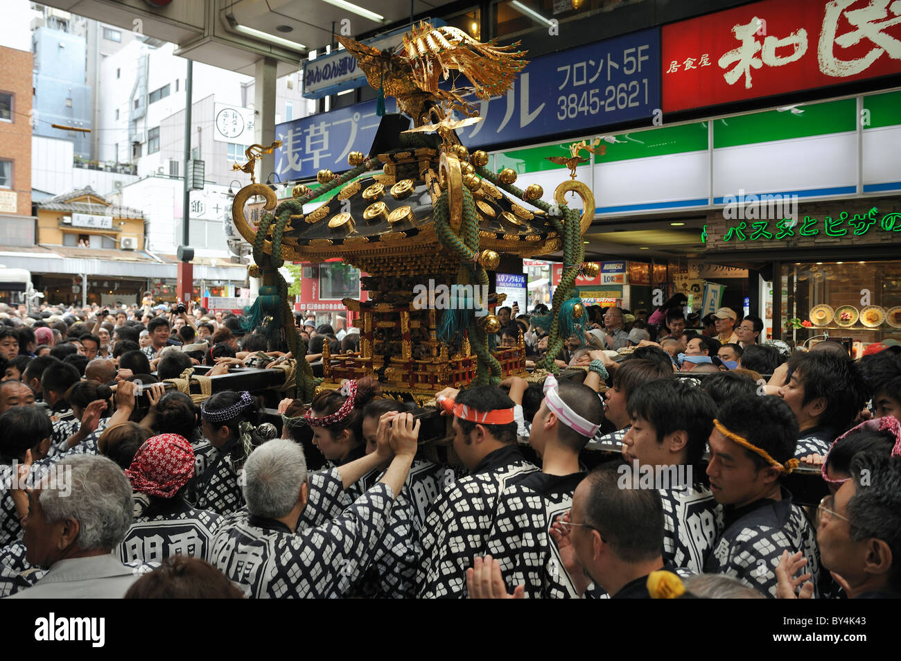 Portable shrine is carried through passage, Sanja Matsuri, Asakusa ...