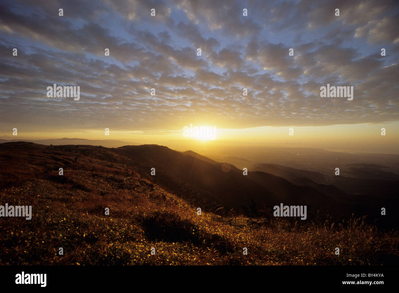 Sun Rising Over Mountains Stock Photo - Alamy
