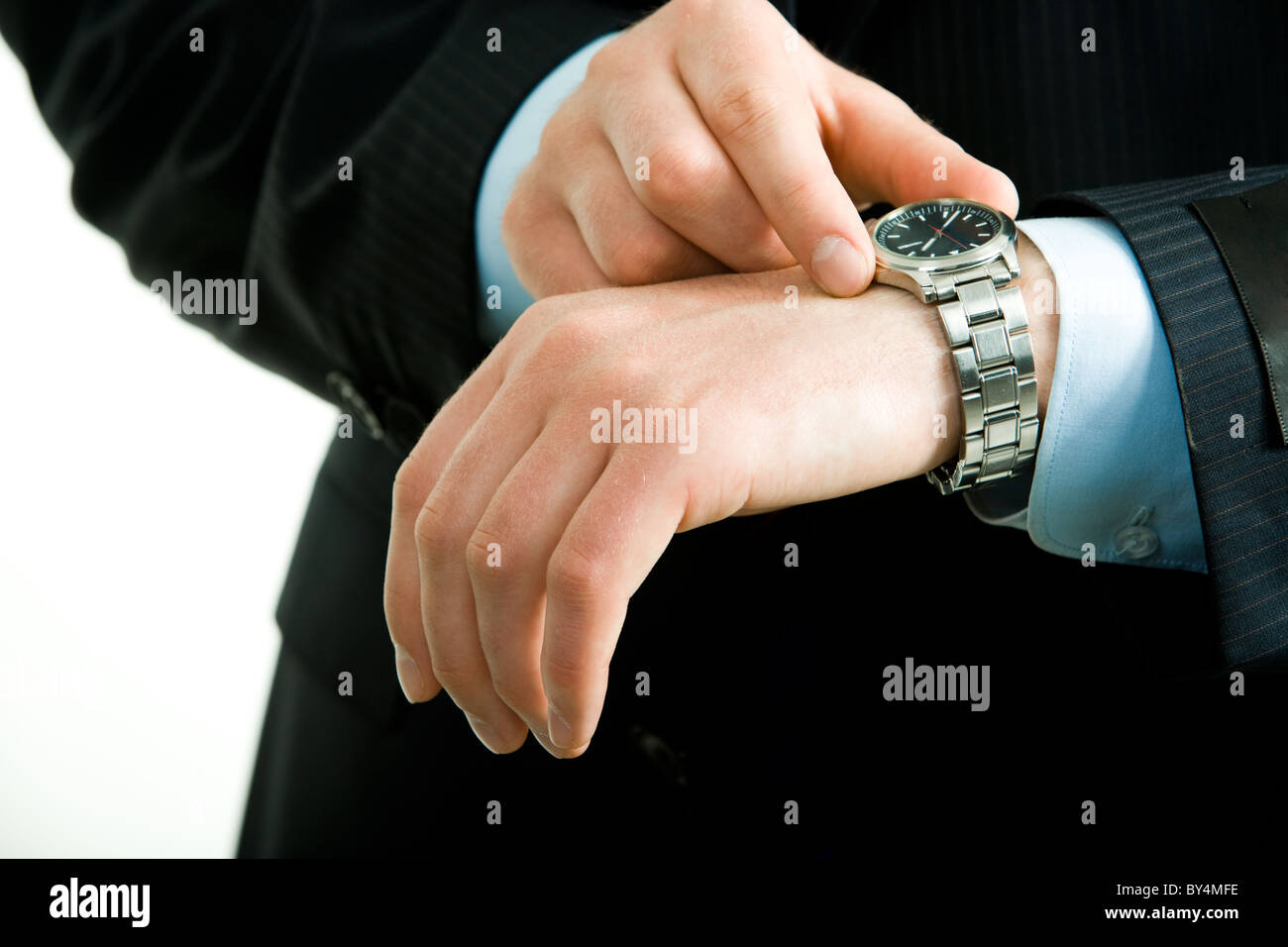 Closeup of businessman’s hand with watch on it while he checking the ...
