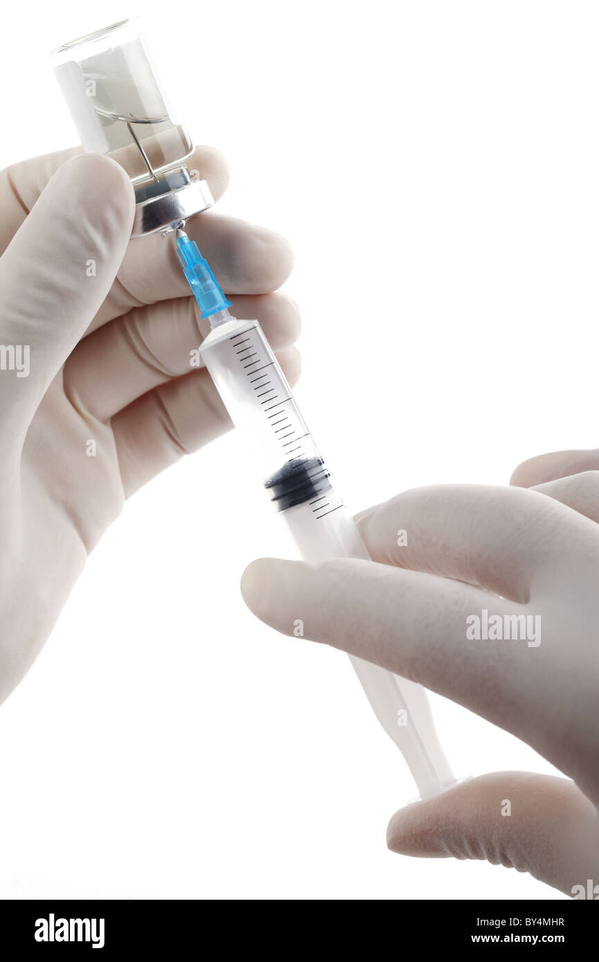 Close up of hands with syringe and vial of medication Stock Photo - Alamy