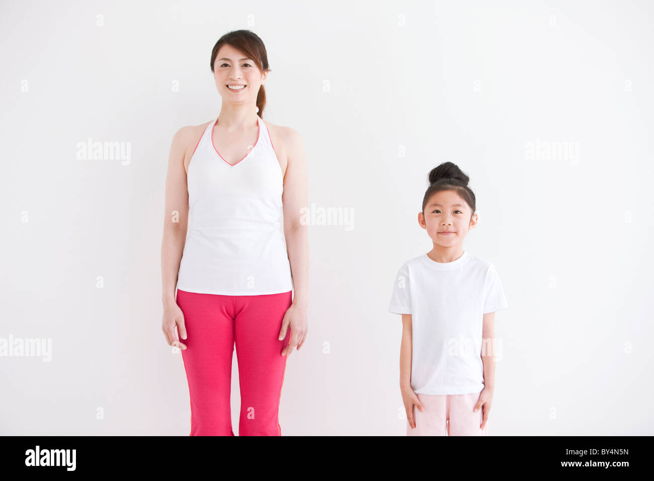 Mother and Daughter Standing Side by Side Stock Photo - Alamy