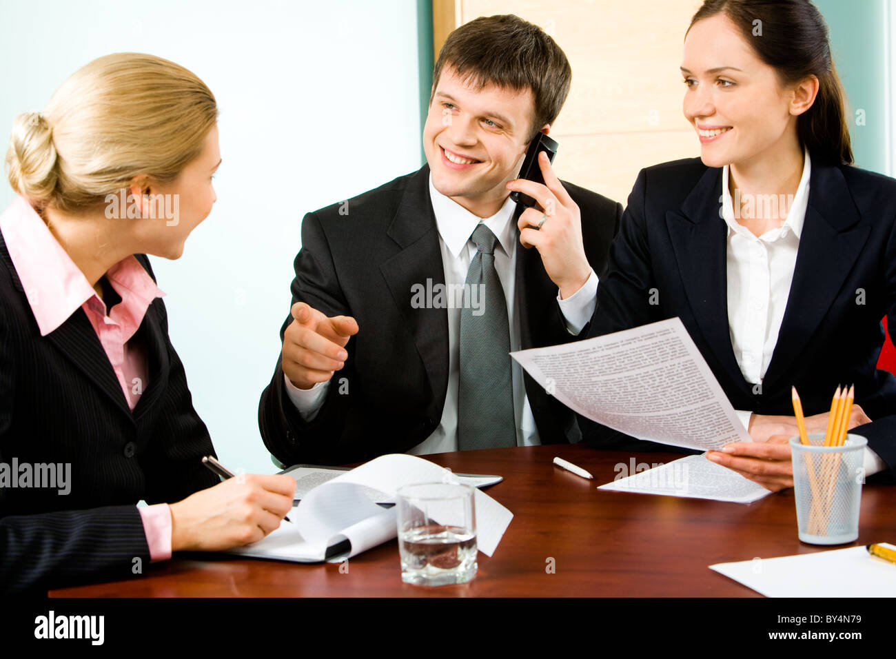 Portrait of business man telling something to colleague while calling ...