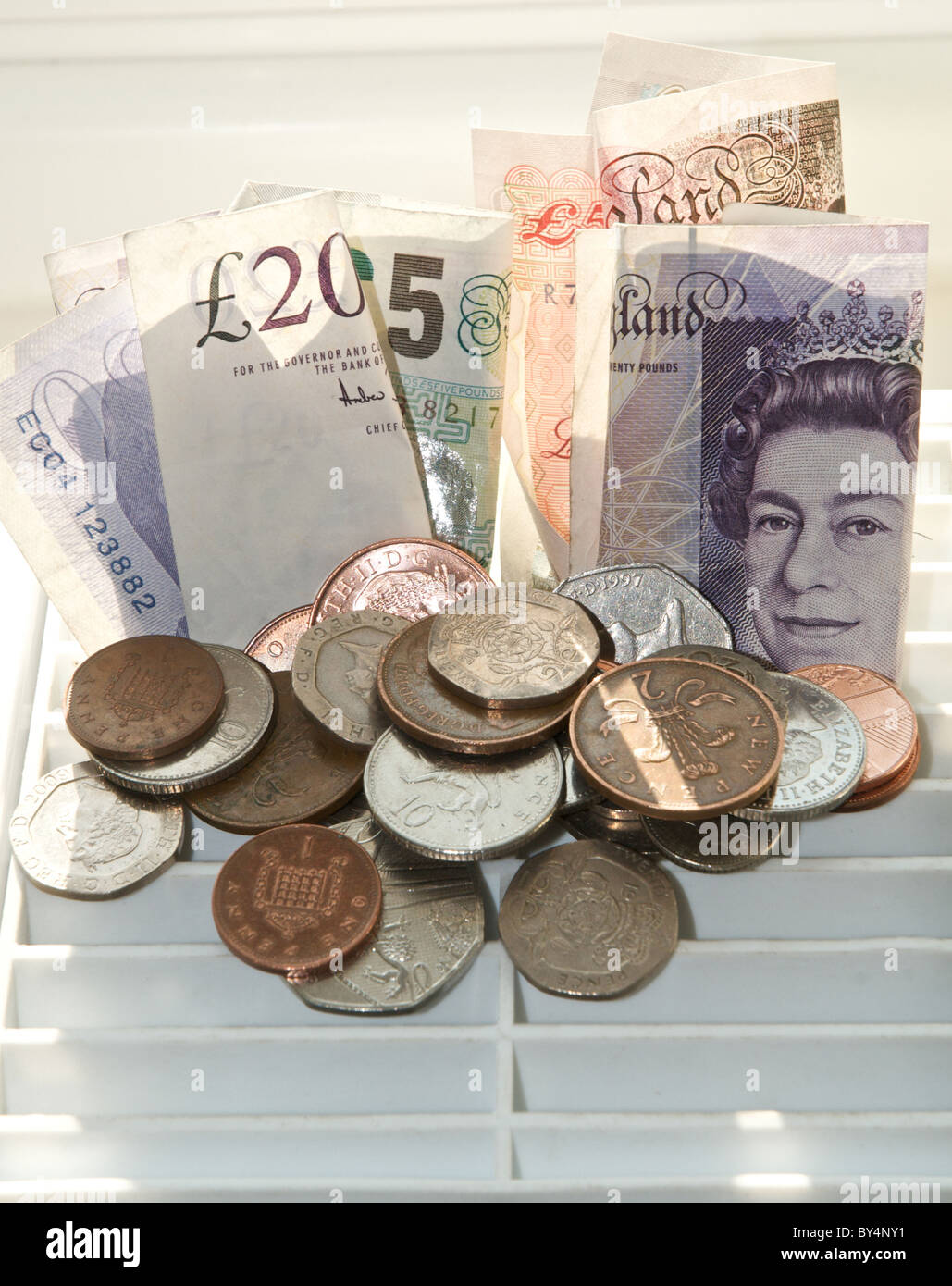 Money down the drain, wasted cash UK currency Stock Photo - Alamy