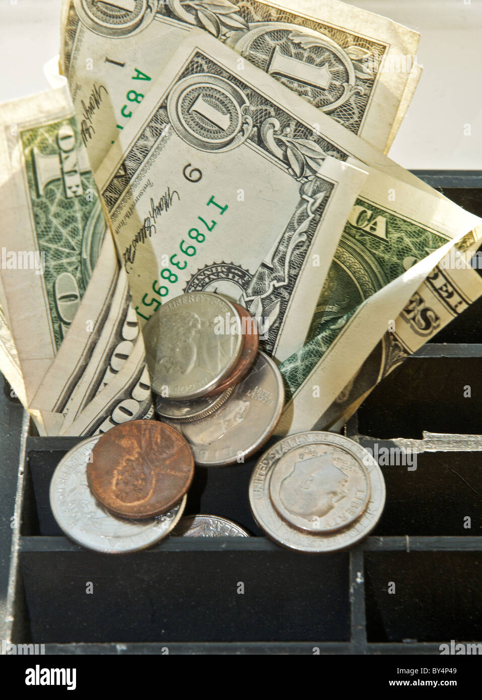 Dollars down the drain. US United States currency Stock Photo - Alamy
