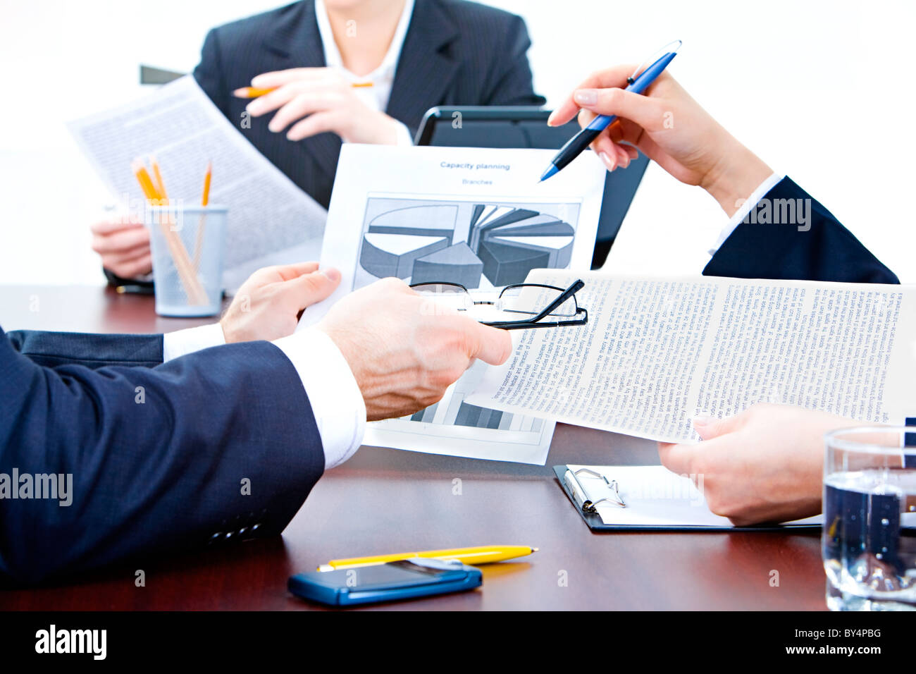 Image of human hands holding the papers and pens Stock Photo - Alamy