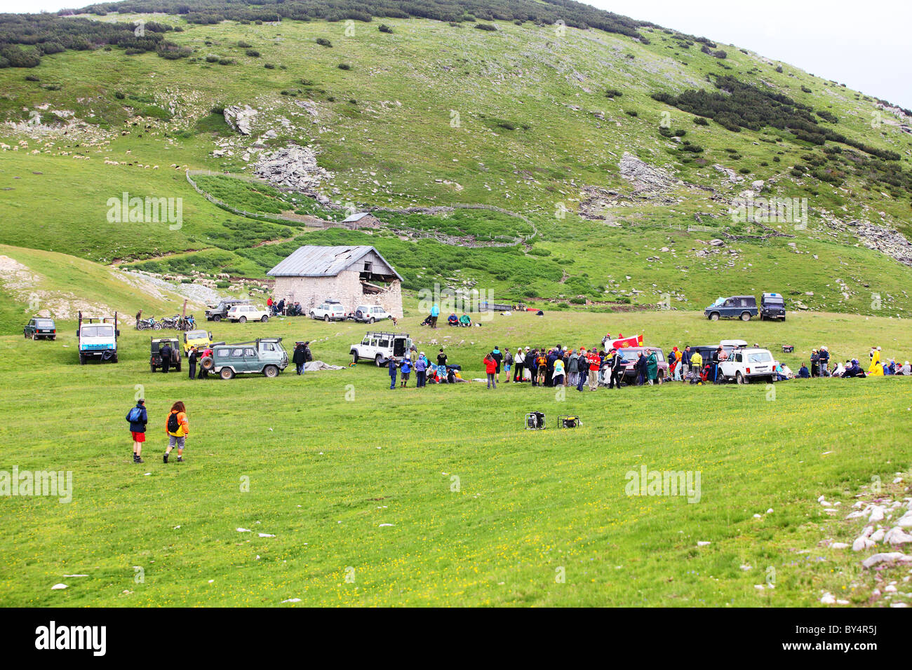 mountaineers gathering on the Begovo Field, below mountain peak ...
