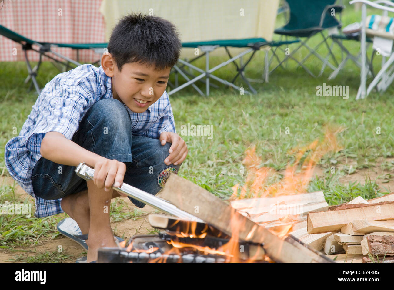 Boy starting a campfire, Chiba Prefecture, Honshu, Japan Stock Photo ...