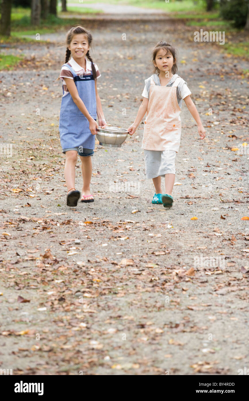 Girls holding a bowl of washed rice, Chiba Prefecture, Honshu, Japan ...