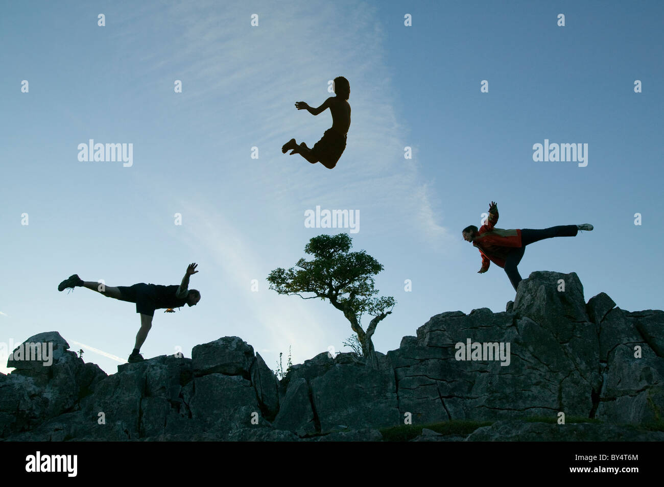a man and women performs aerobic tai chi type exercise on limestone ...