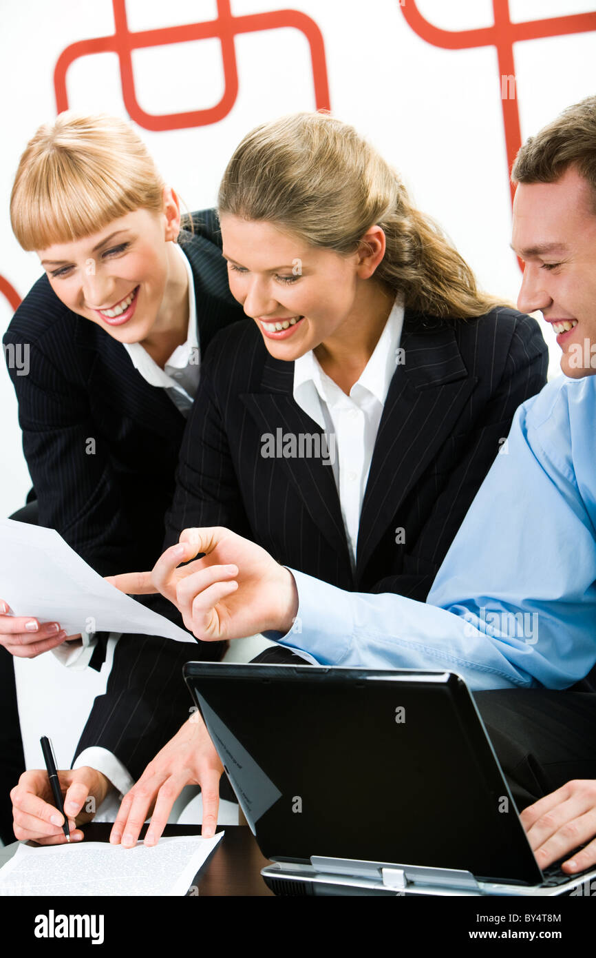 Vertical image of three business people working together Stock Photo ...