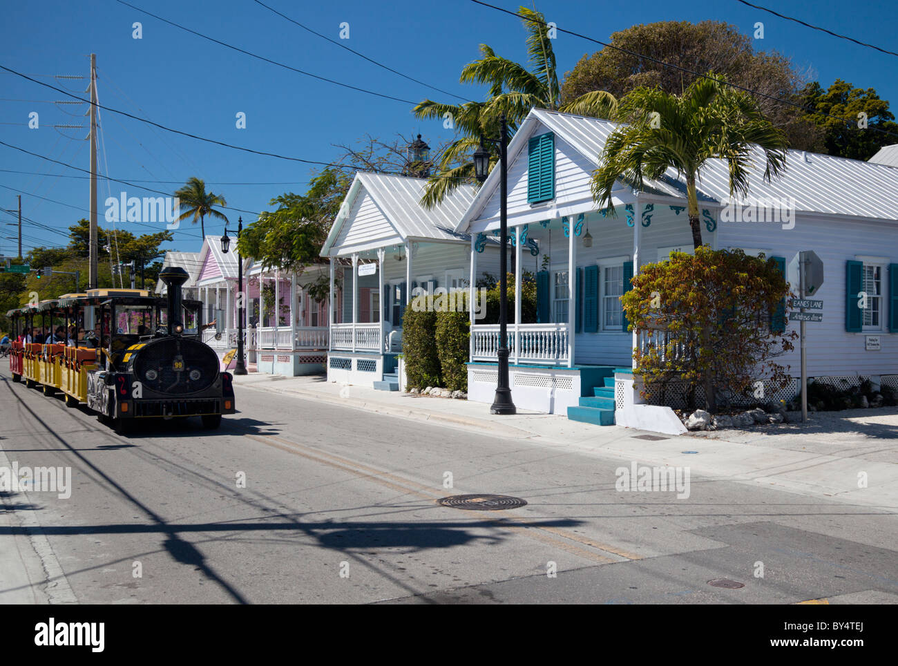 The Conch Tour Train passes a row of pretty little cottage style houses ...