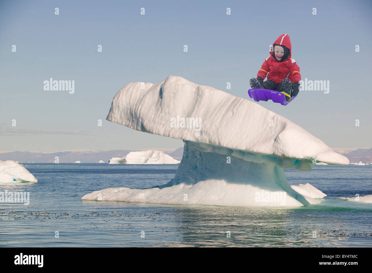 Child sledging across an iceberg Stock Photo - Alamy