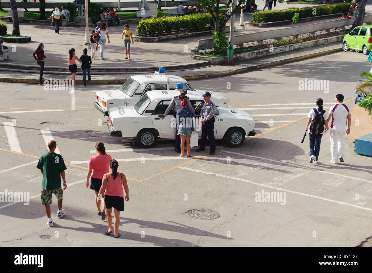 Street scene in Holguin Cuba with 2 policemen with police cars and ...