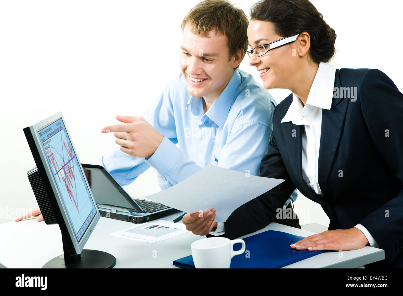 Portrait of business woman and man looking at the monitor of computer ...