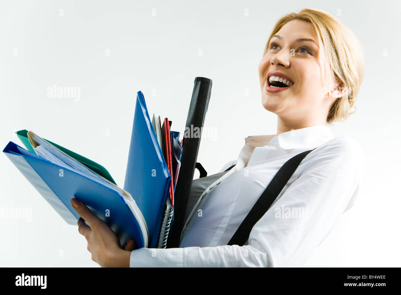 Pretty student holding the folders and laughing Stock Photo - Alamy