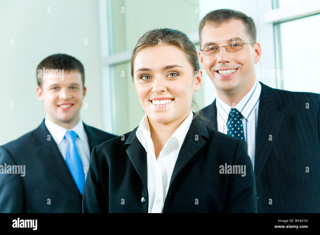 Portrait of pretty leader on the background of business team Stock ...