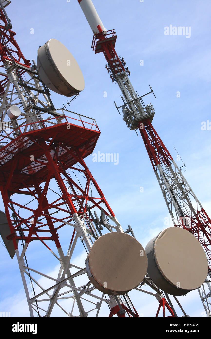 A mast with satellite dishes for digital communication sending signals ...