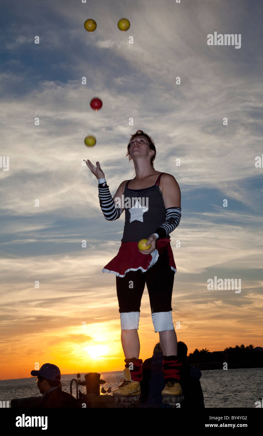 Sunset street entertainer juggling at Mallory Square, Key West, Florida ...