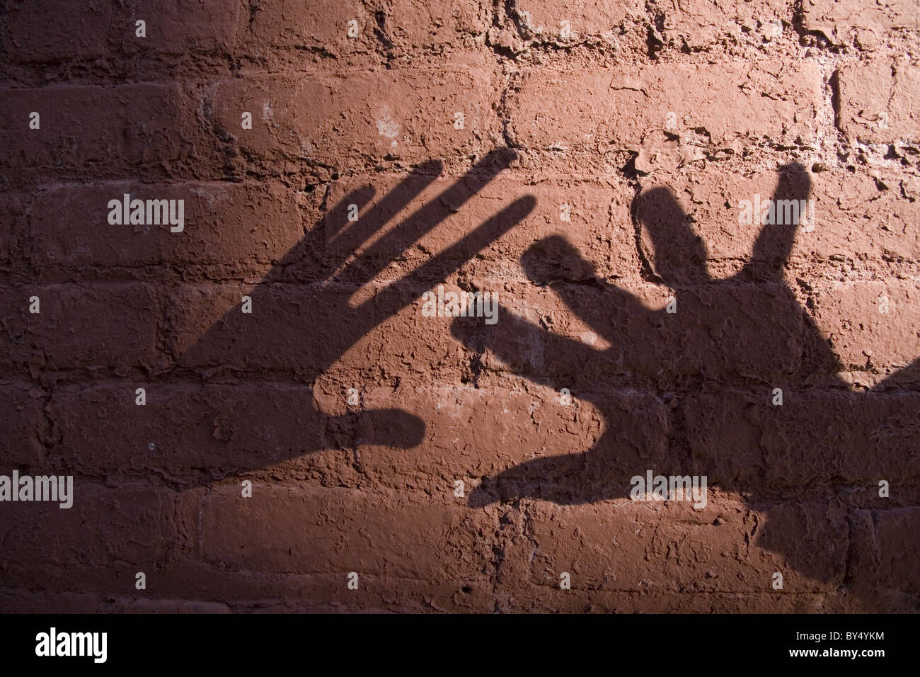 Expressive hand shadows on a brick wall Stock Photo - Alamy