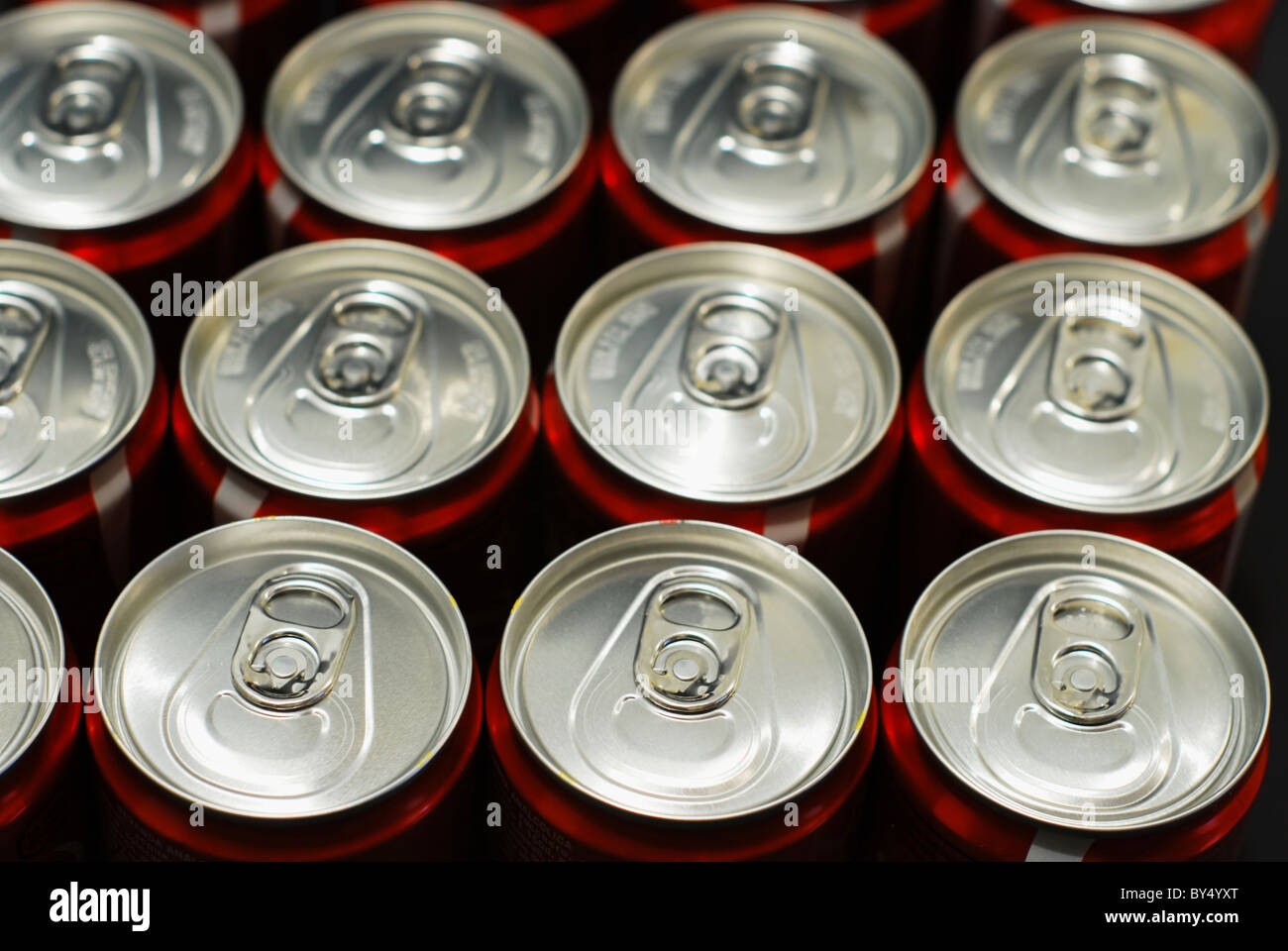 Group of tin drinks in rows on black background Stock Photo - Alamy
