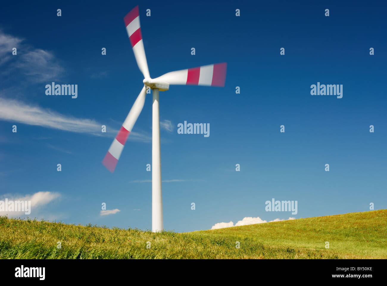 Wind turbine moving in summer meadows Stock Photo - Alamy