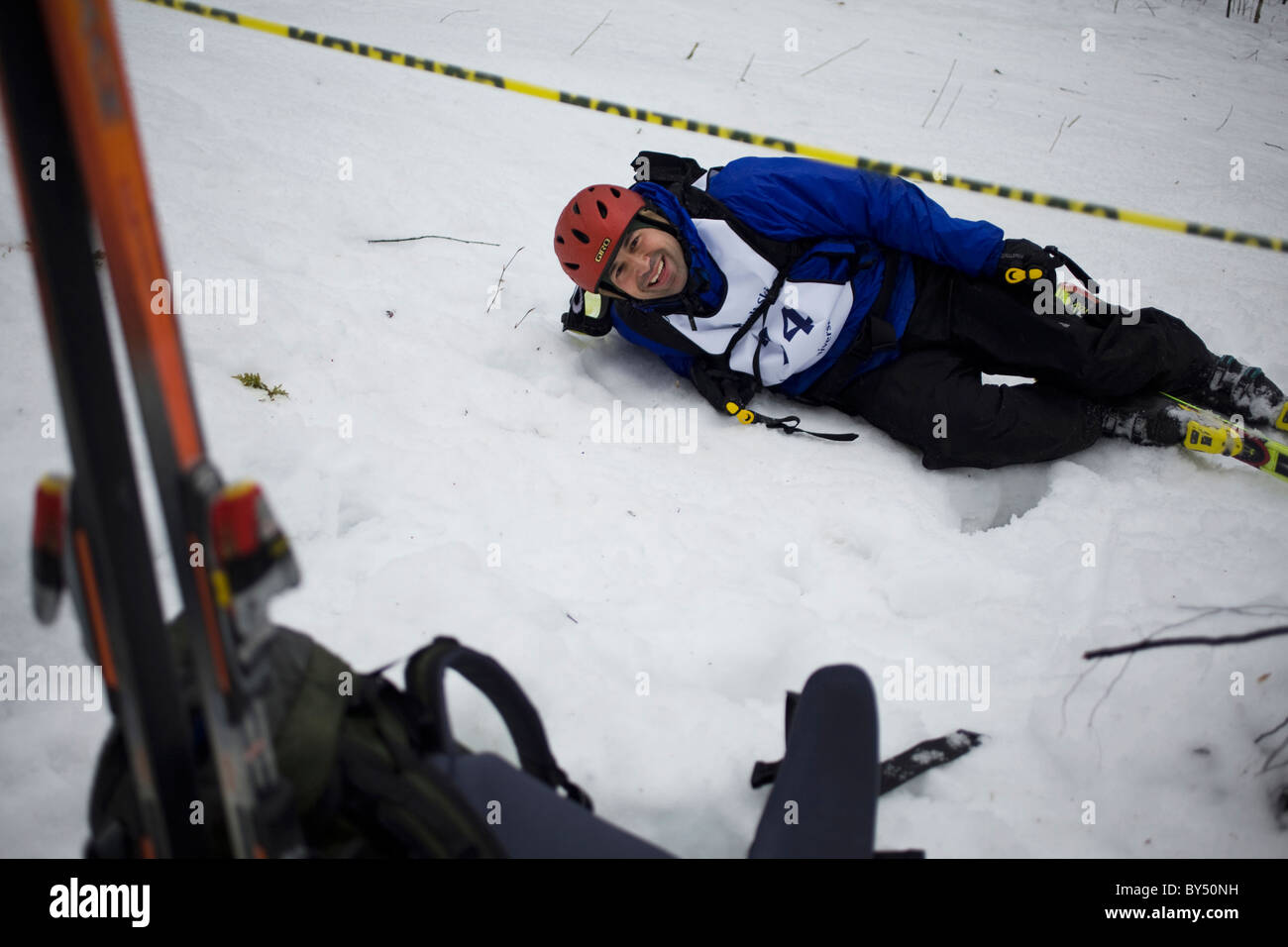 A happy and exhausted skier collapses just after crossing the finish ...