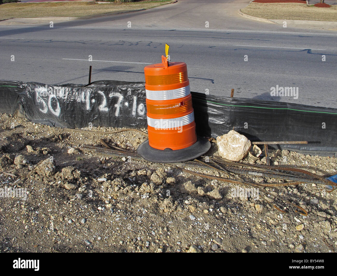 Orange warning barrel at construction site in Austin Texas Stock Photo ...
