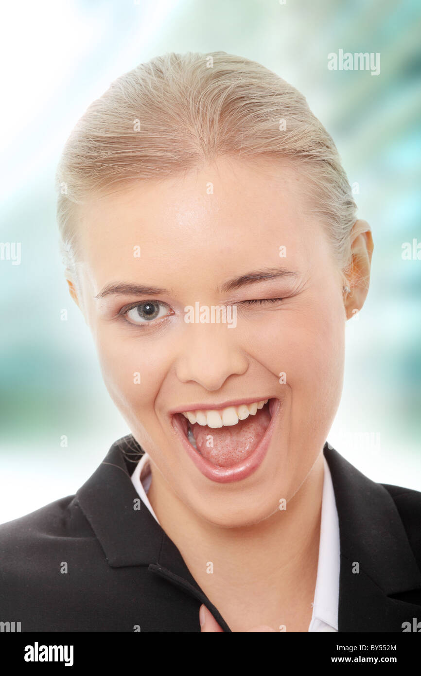 Businesswoman with big smile blinking Stock Photo - Alamy
