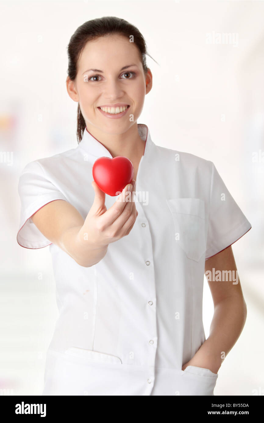 Young nurse with heart in her hand Stock Photo - Alamy