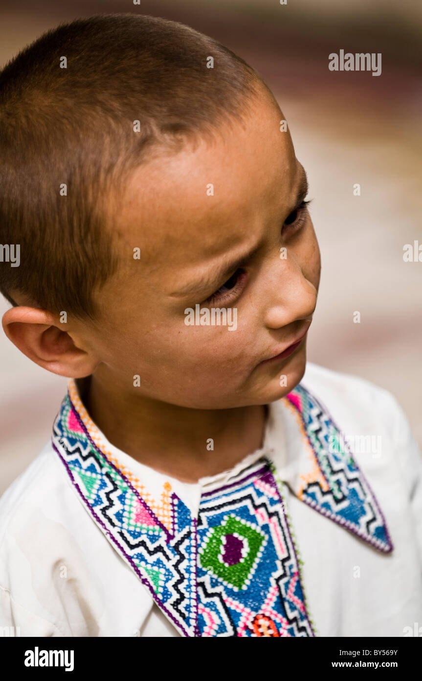 An Uyghur boy wearing a traditional shirt Stock Photo - Alamy
