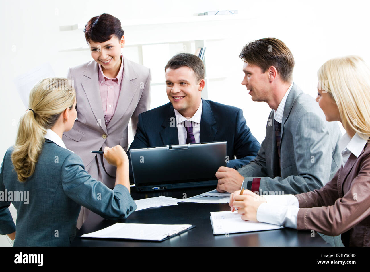 Image of smiling people watching at confident woman while she sharing ...