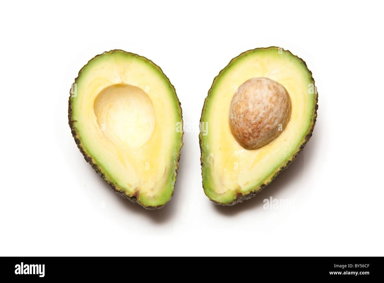 Avocado pear halved and isolated on a white studio background Stock ...