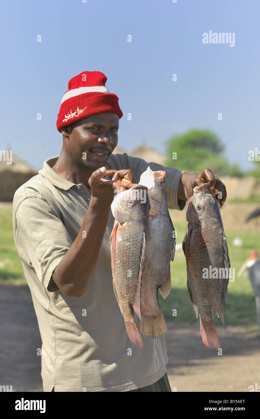 Fisherman selling fish in a village near Lake Victoria Stock Photo - Alamy