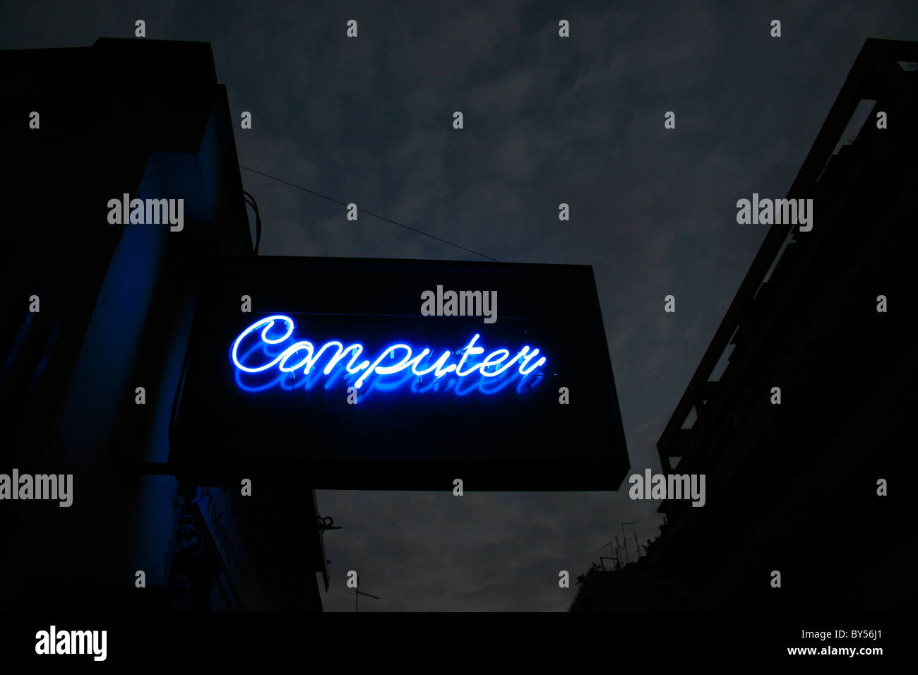 blue neon computer shop sign notice in city town Stock Photo - Alamy