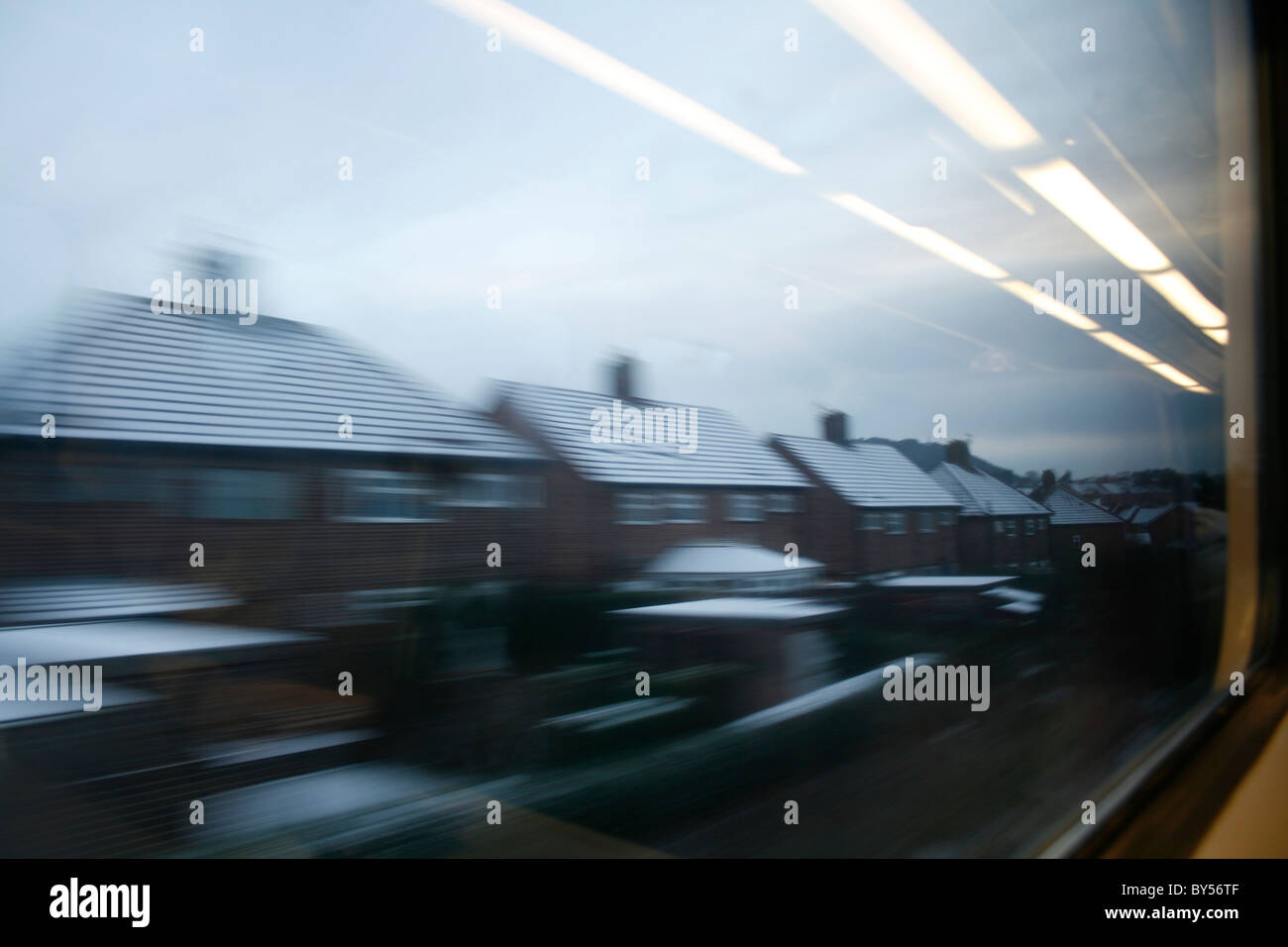 view of snow covered landscape from fast train window Stock Photo - Alamy