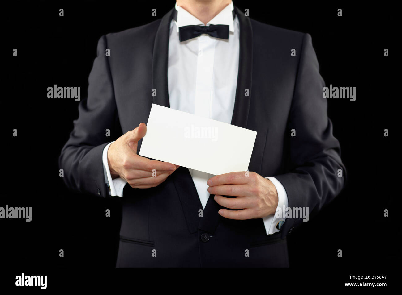Man tuxedo holding envelope hi-res stock photography and images - Alamy