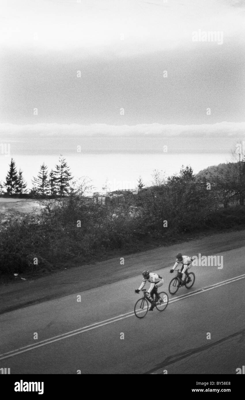 Two men riding racing bicycles, rural setting Stock Photo - Alamy