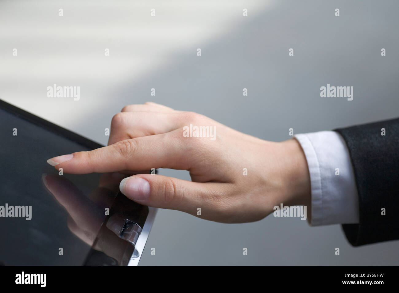 Woman's hand touching tablet computer Stock Photo - Alamy