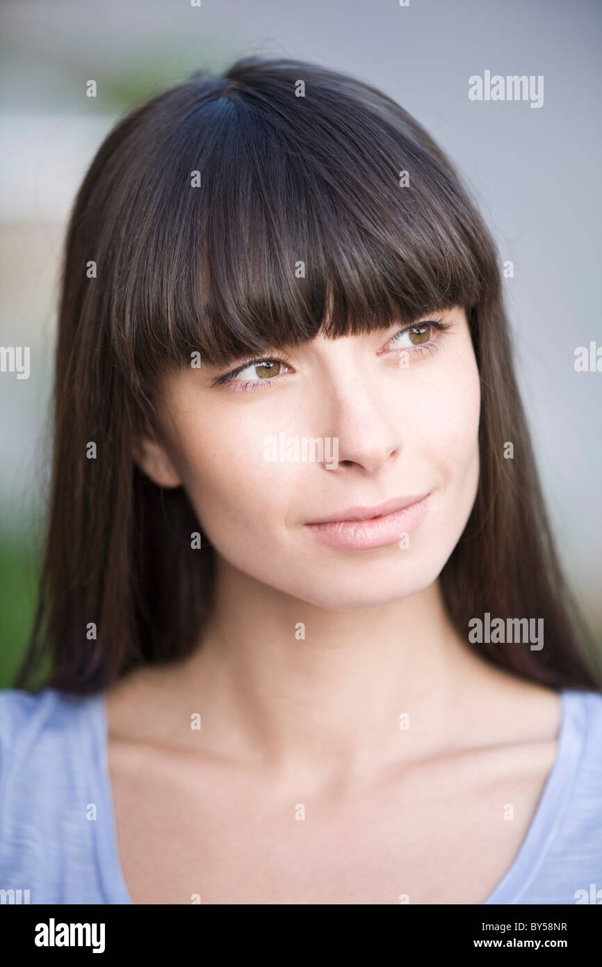 A young woman looking away, portrait Stock Photo - Alamy