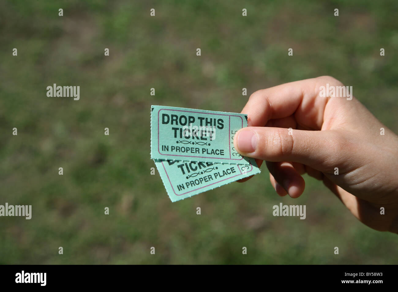 A girl holding two tickets, detail of hand Stock Photo - Alamy