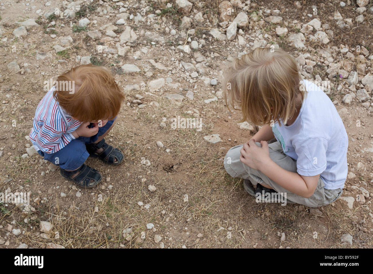 Two kids looking down from hi-res stock photography and images - Alamy