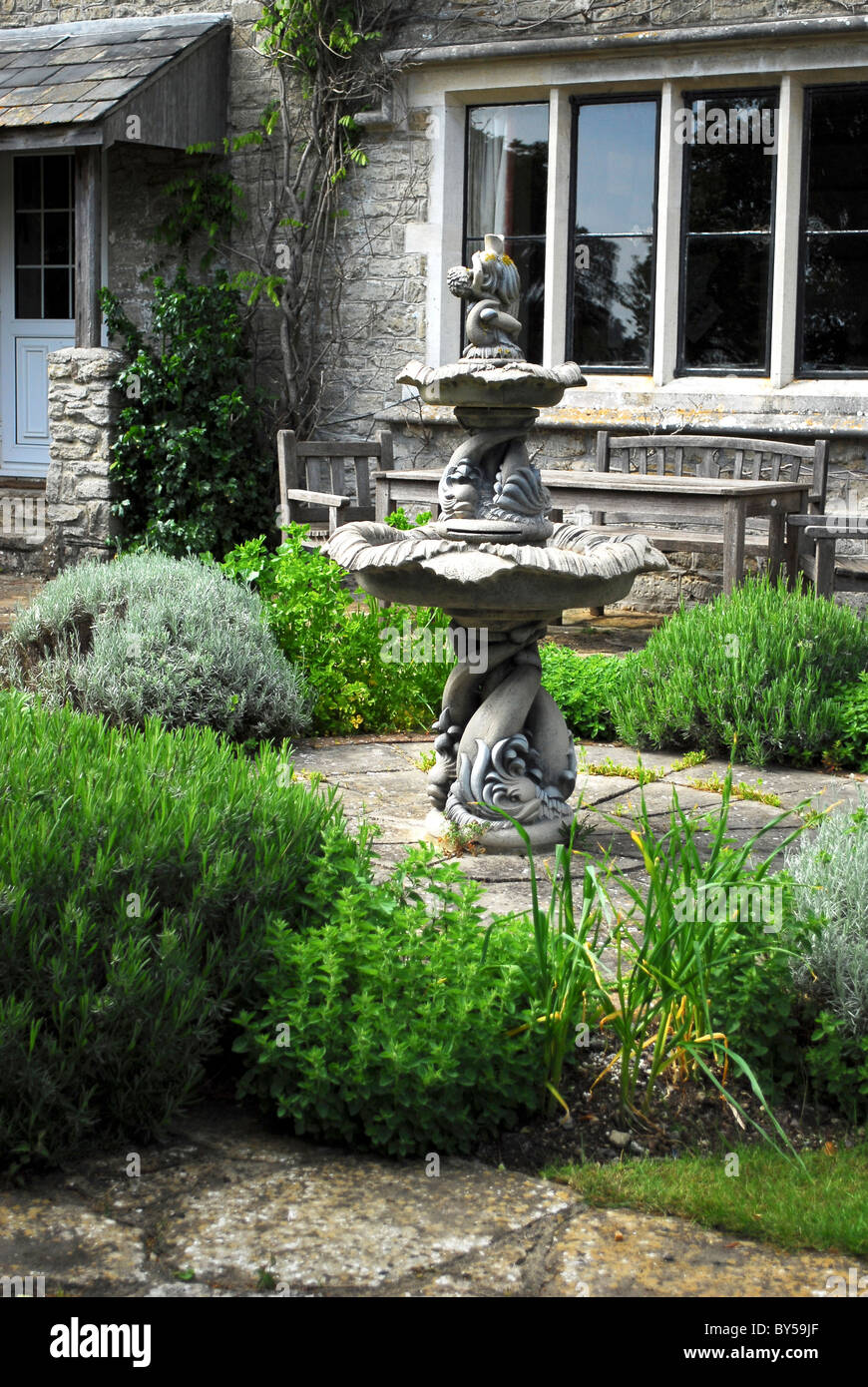 A stone garden sculpture in front of a house. UK July 2009 Stock Photo ...