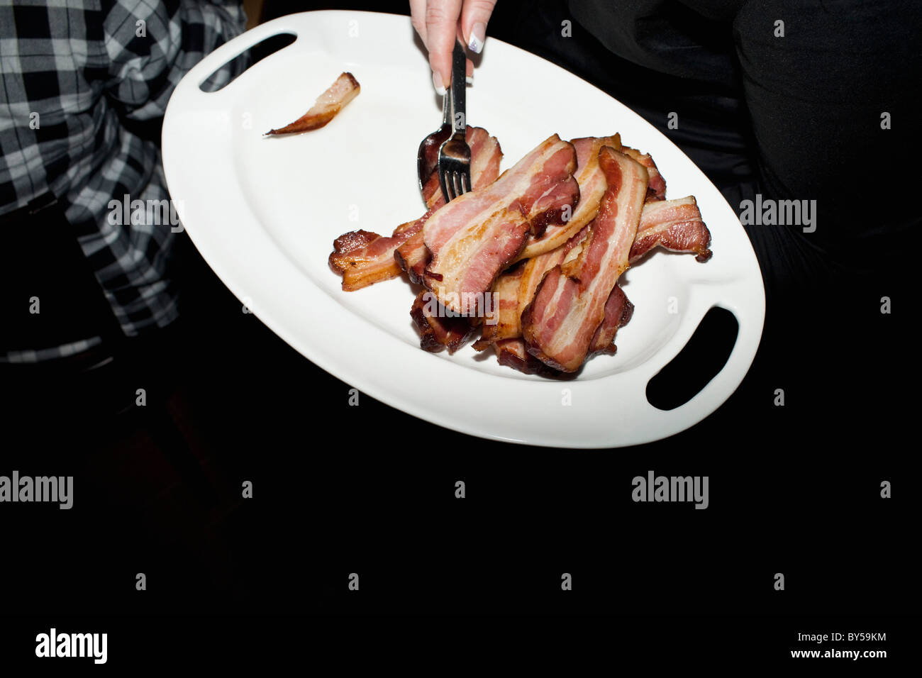 Slices of bacon on a plate Stock Photo - Alamy