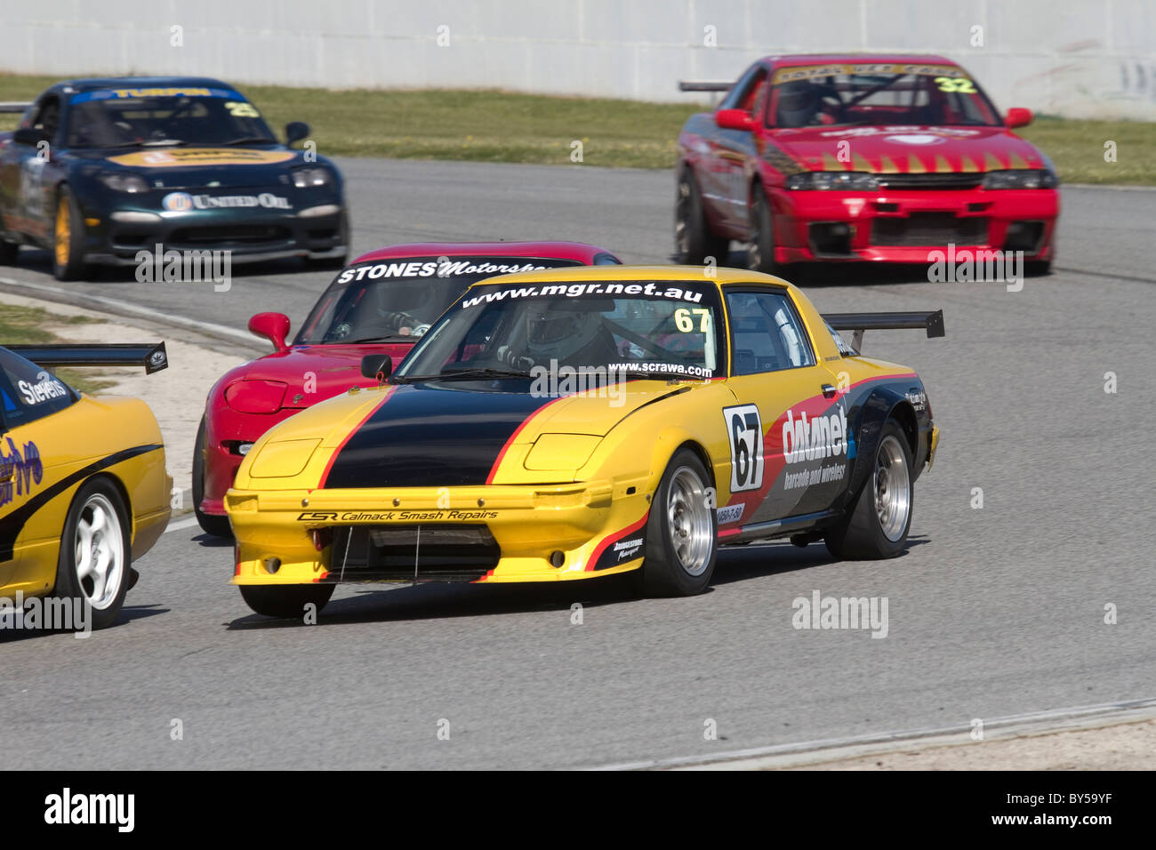Early model Mazda RX7 rotary engined car overtaking competitors around ...