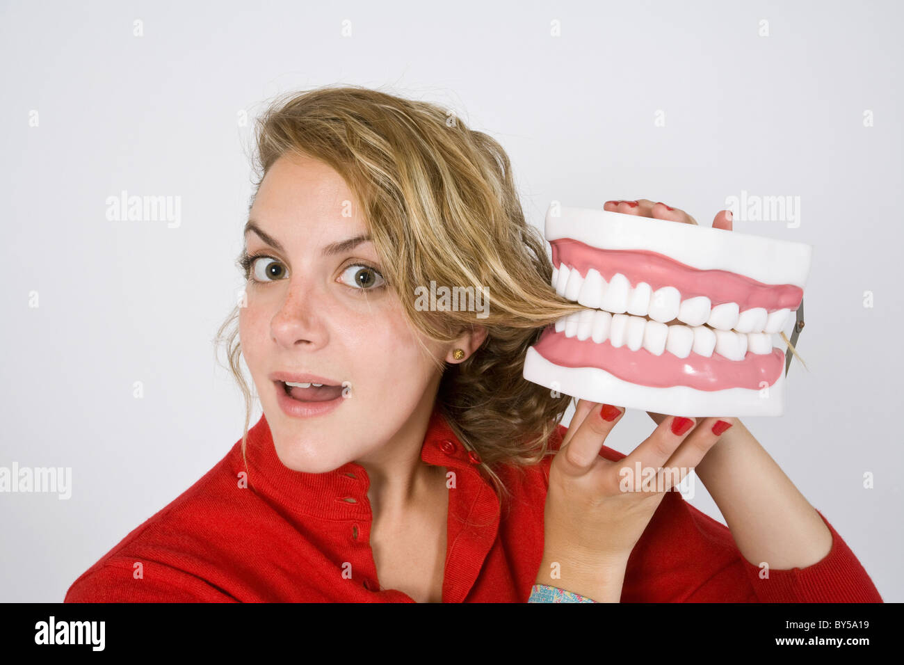 Model teeth biting hair Stock Photo - Alamy